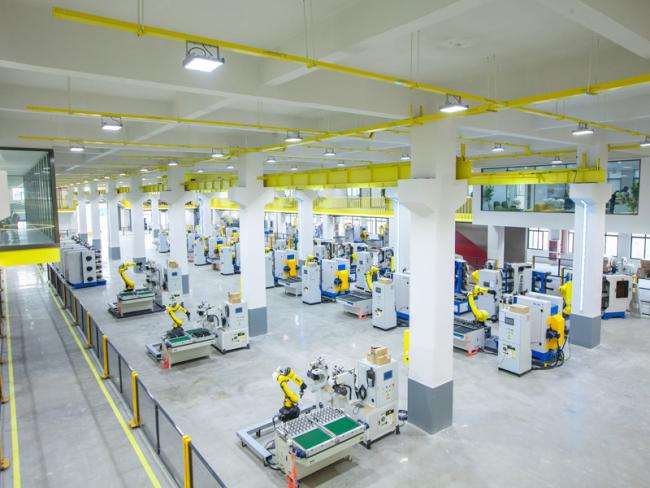 Close-up view of robotic polishing head applying finish to brass faucet component
