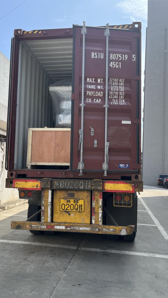Machine components secured and loaded into shipping container
