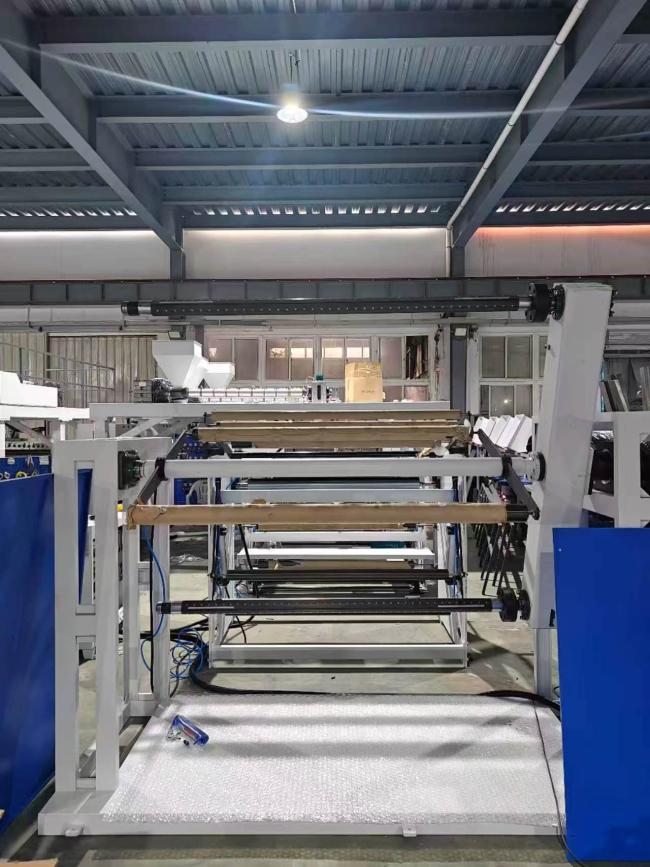 PE air bubble film making machine production line overview showing extruder, bubble forming rollers, and winding system