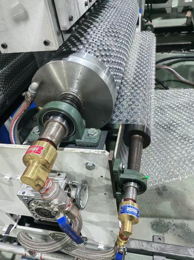 Close-up detail of the forming roller unit on the air bubble film machine