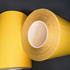 Heavy-duty transparent mounting tape applied to a surface showing strong adhesion