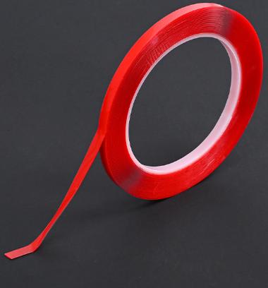 Red PE film release liner on double sided acrylic tape close-up