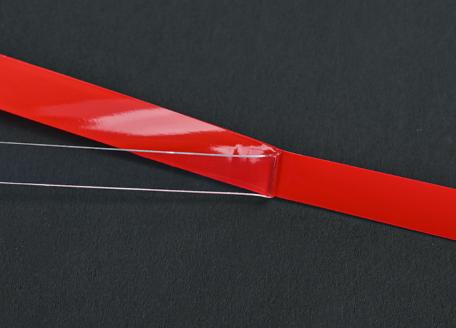 Clear acrylic double sided tape with red liner roll view