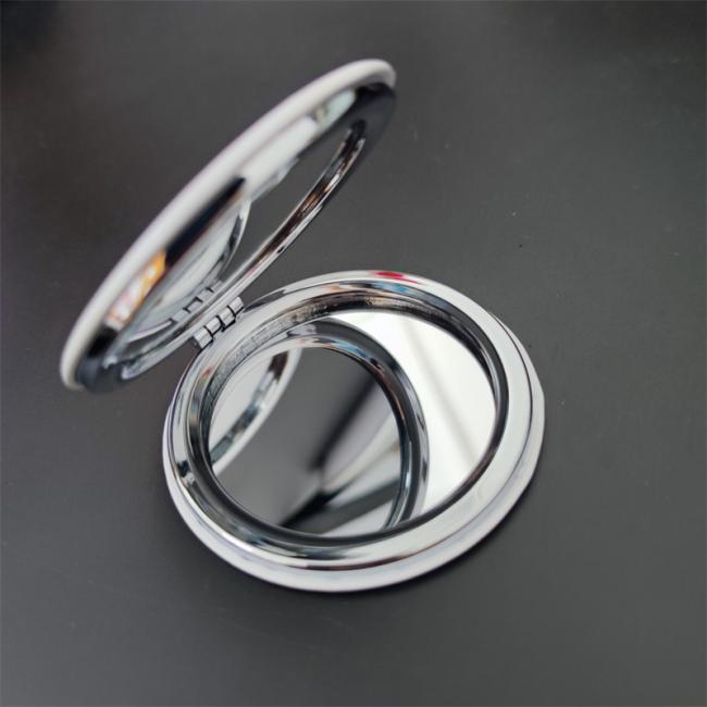 Close-up view of the acrylic mirror showing clear reflection and sturdy metal frame