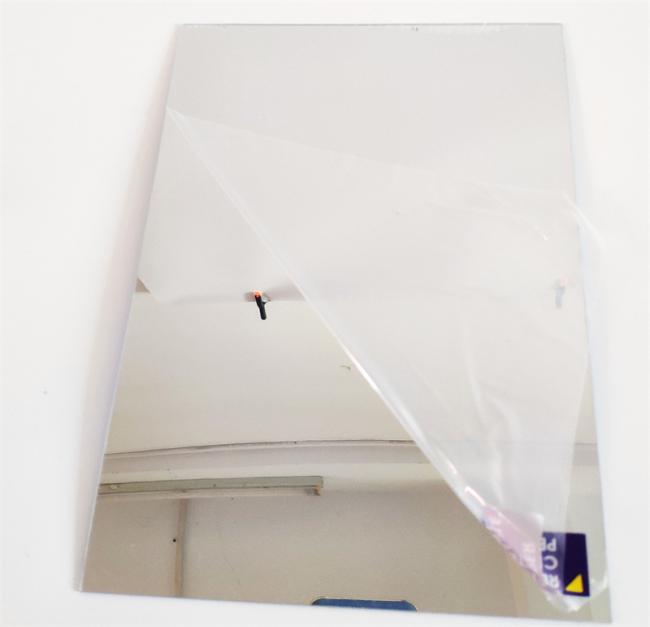 PVC mirror sheet applied to curved surface demonstrating flexibility and adhesion