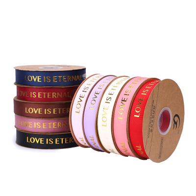 Cina Wholesale Custom Washable Logo Printed Gold Foil Polyester Satin Ribbon For Wrapping Decoration in vendita
