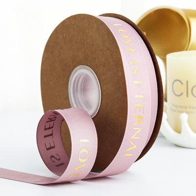 Cina Viable Wholesale Polyester Grosgrain Ribbon With Logo Foil Gold Printed For Gift Packing in vendita