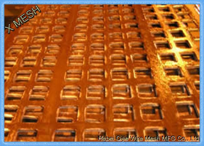 A piece of square perforated screen mesh and some oil on it.