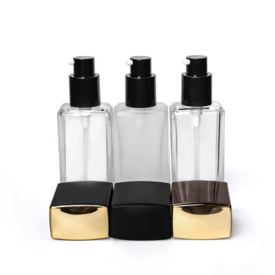 China Square Shaped 30ml Empty Liquid Foundation Glass Bottle With Gold Top Pump for sale