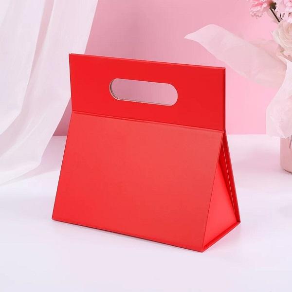 Red triangular rigid gift box with integrated die-cut carrying handle