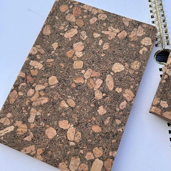 Flat lay view of the spliced coffee cork hardcover notebook showcasing the two-tone cover architecture