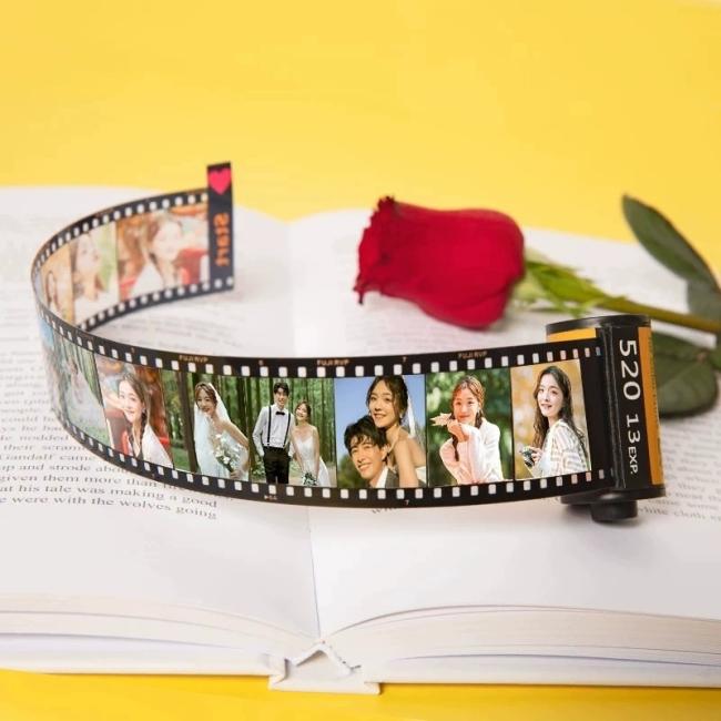 Full view of custom film roll keychain showcasing extended photographic strip with professional print quality