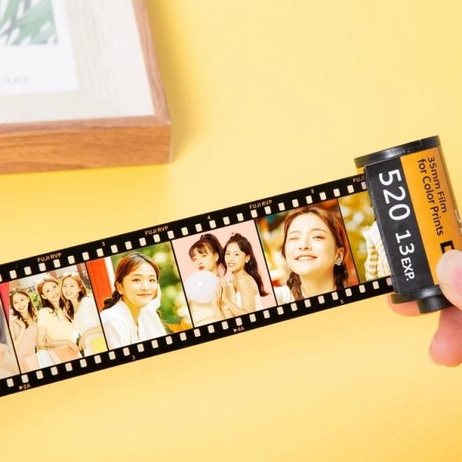 Close-up of personalized photo strip extending from film canister showing vibrant image reproduction