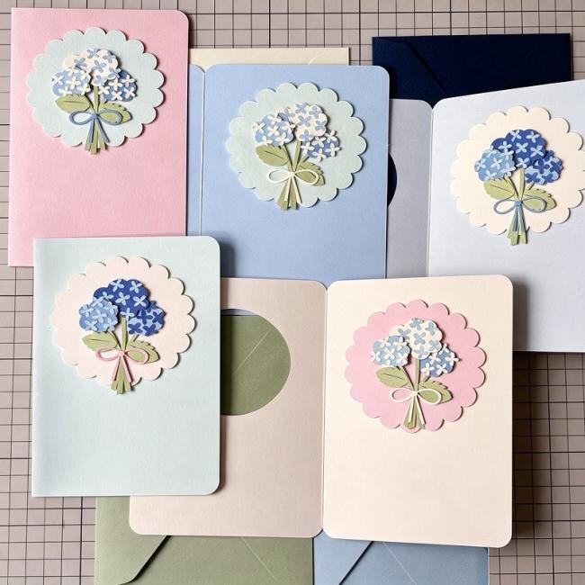Open view of handmade greeting cards showing multi-layered 3D paper flower arrangements and internal structure