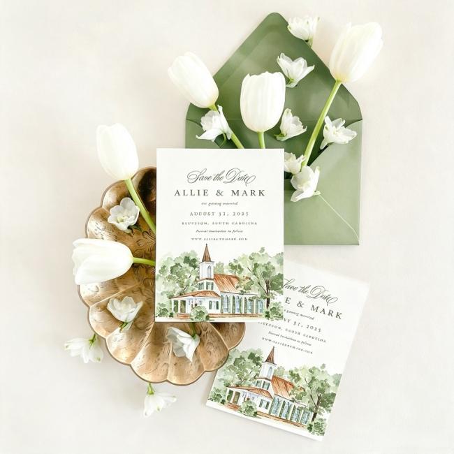 Greenery chapel watercolor illustration wedding invitation set displayed against soft green background