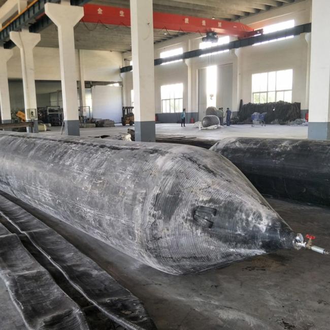 Multiple marine airbags arranged beneath large vessel