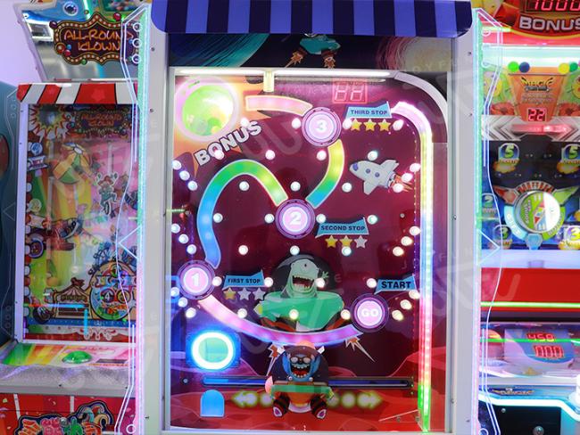 Space-themed arcade machine display with vibrant colors and LED effects