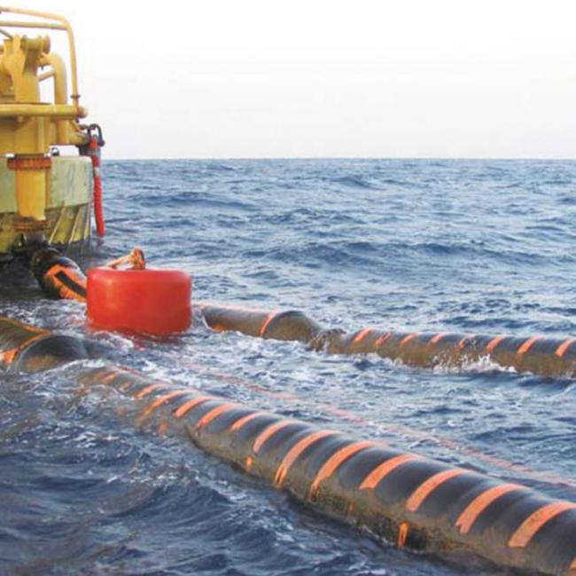 Close-up view of dredge hose connection and flotation
