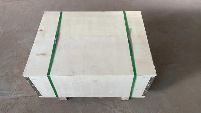 Stainless steel filter discs secured in wooden crate for transport