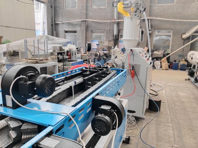 Close-up view of corrugated pipe production