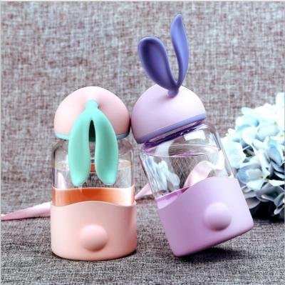 China 340ml Kids Rabbit Shaped Gift Unbreakable Glass Water Bottle With Silicone Sleeve for sale