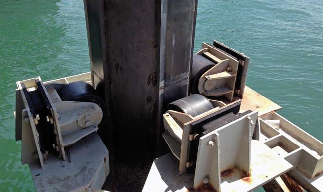 Close-up view of Roller Fender mechanism showing rubber roller and steel mounting brackets