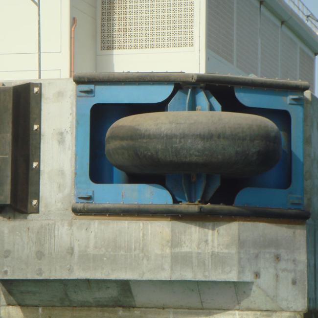 Roller Fender installation at marine terminal showing cylindrical rubber roller mounted on steel support structure