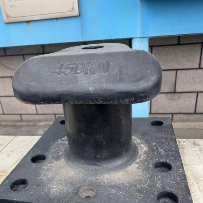 Close-up view of a mooring bollard head and rope-contact geometry at a marine facility