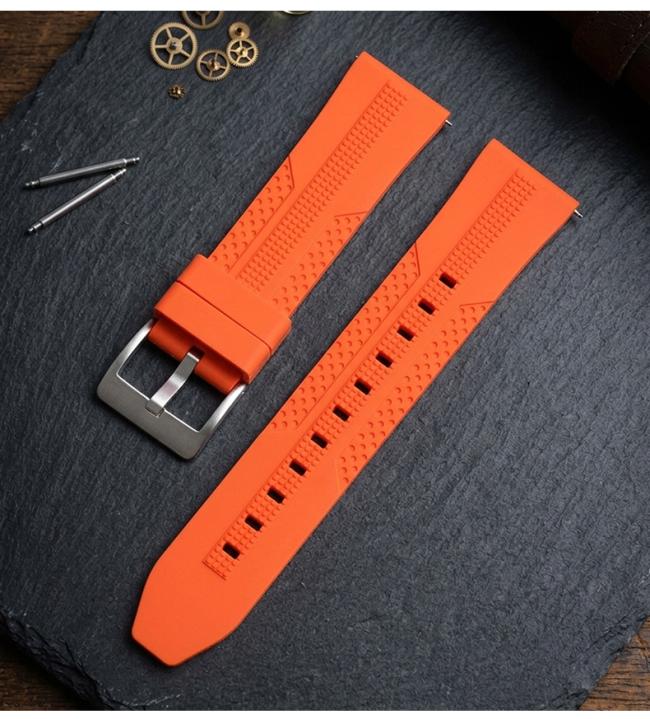 Sunset Orange FKM rubber strap with textured grid and steel buckle.