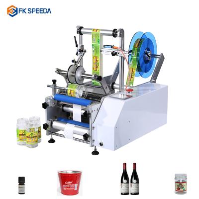 China Wine beer round bottle placing labeling machine FK-SPEEDA wholesale price semi-automatic round sticker applicator label bottle candle labeling machines Te koop