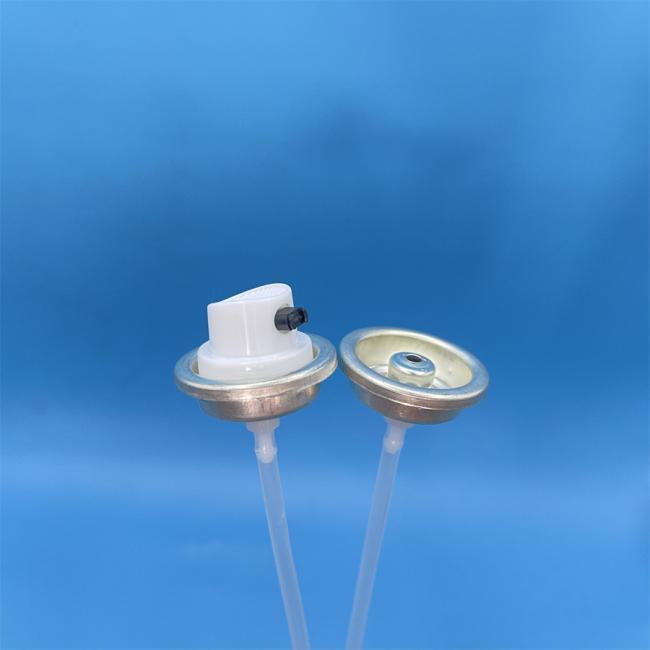 Demonstration of female aerosol valve in use spraying adhesive