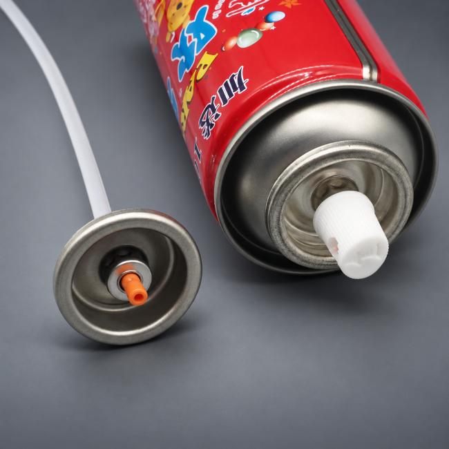 Front perspective of the One Inch aerosol valve assembly with colored ribbon actuator
