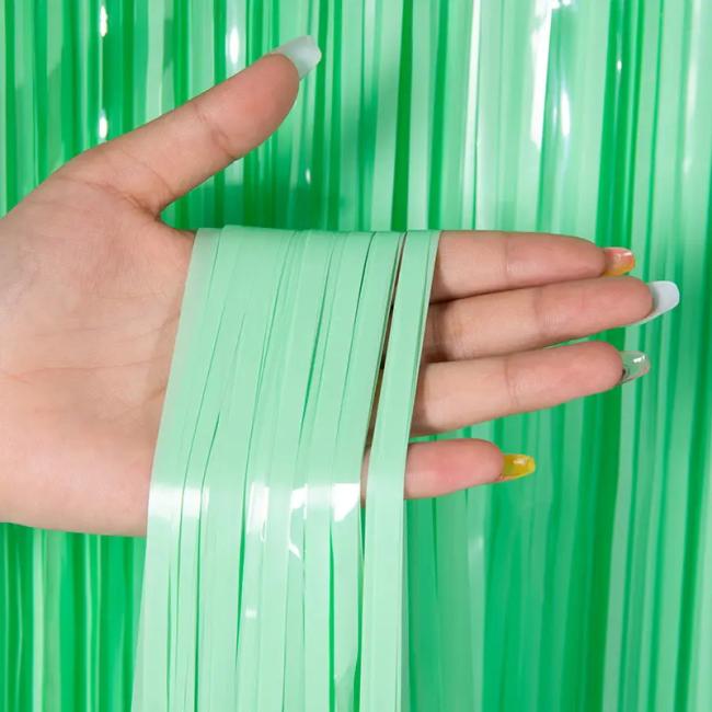 Fluorescent blue foil fringe curtain displayed as festive background decoration
