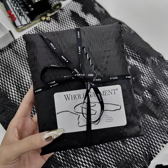 Black honeycomb paper product demonstration showing expanded matte black texture