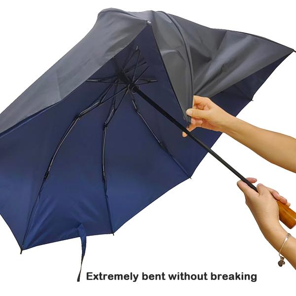 The umbrella was blown by the strong wind, and its ribs bent significantly, but it would not break.