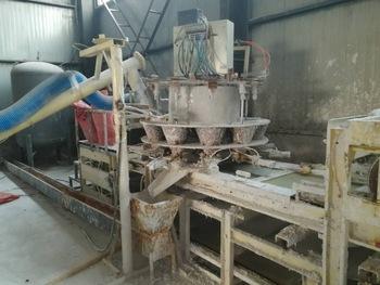 Gypsum ceiling tile processing machinery in operation