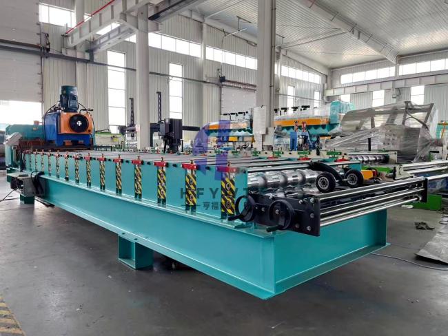 Close-up of 970 glazed tile roll forming machine forming rollers and gear transmission system