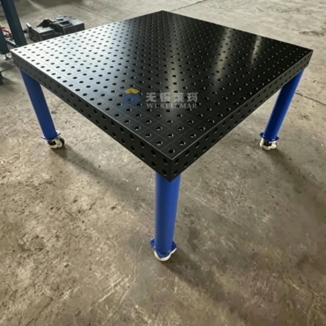 Welding table in use with clamping fixtures
