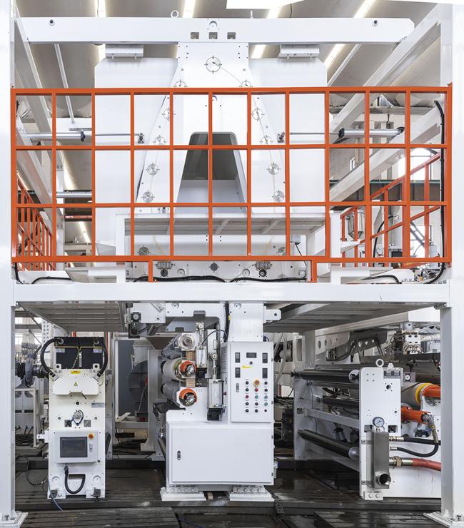 Detailed view of extrusion laminating machine parts