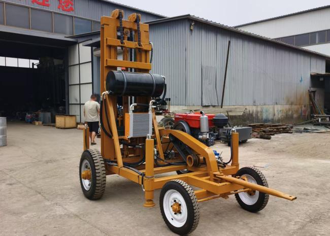 Portable four-wheel tractor borewell machine in operation