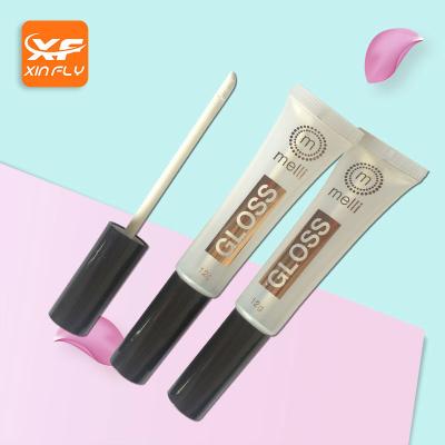 China Impreso a la medida Estampado en caliente Contenedor de tubos transparentes de plástico con brillo labial vacío Tubos de compresión suaves con brillo labial con varilla en venta