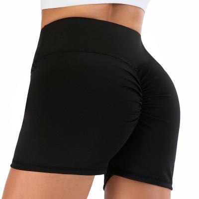 Cina L'yoga di allenamento delle donne mette l'alto bottino in cortocircuito della vita per sgranocchiare i pantaloncini increspati in vendita