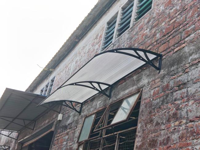Close-up of polycarbonate awning bracket connection