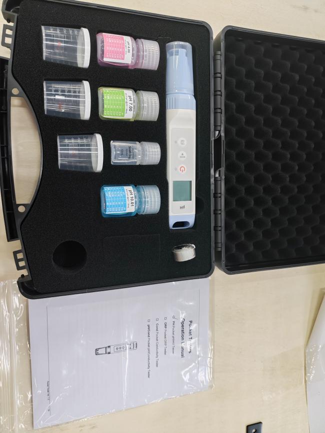 Close-up view of the water quality tester probe and measurement interface