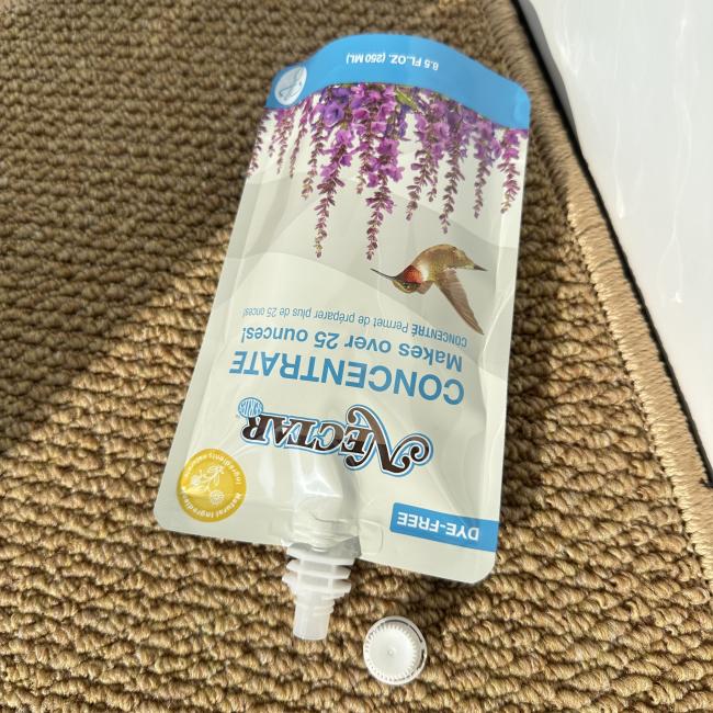 lay flat shot of custom 250ml hummingbird nectar concentrate spout stand‑up pouch, full‑color printed liquid bag