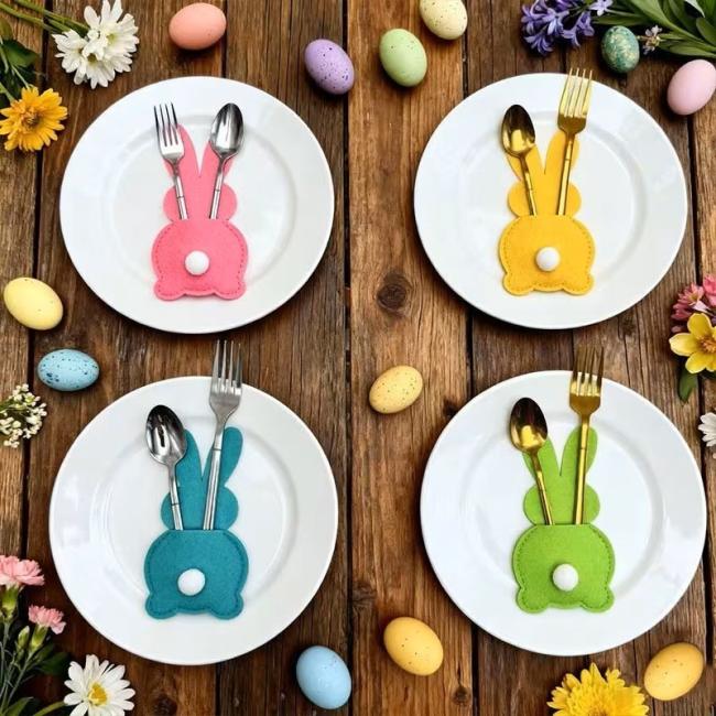 Close-up of thickened felt Easter placemat with cute rabbit design holding silverware