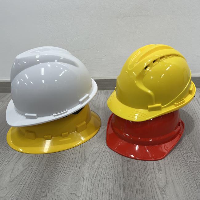 Protective helmet in orange high visibility color for outdoor use