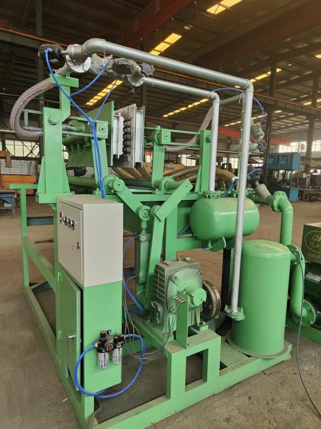 Close-up of egg tray machine components