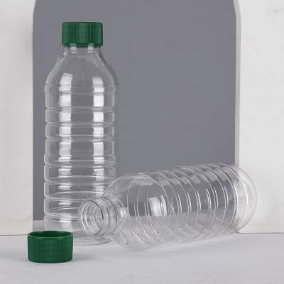 China Custom 300ml Empty Transparent Round Juice PET Plastic Drinking Bottles Spring Water Beverage Container with Lids for sale