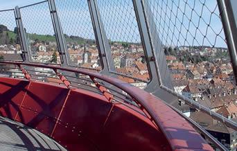 Stainless steel cable mesh infill panels form a safety fence on rooftop to minimize fall accidents.